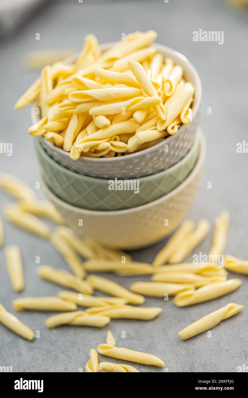 Fusilli pugliesi. Italian twisted pasta in bowl on the gray table Stock ...
