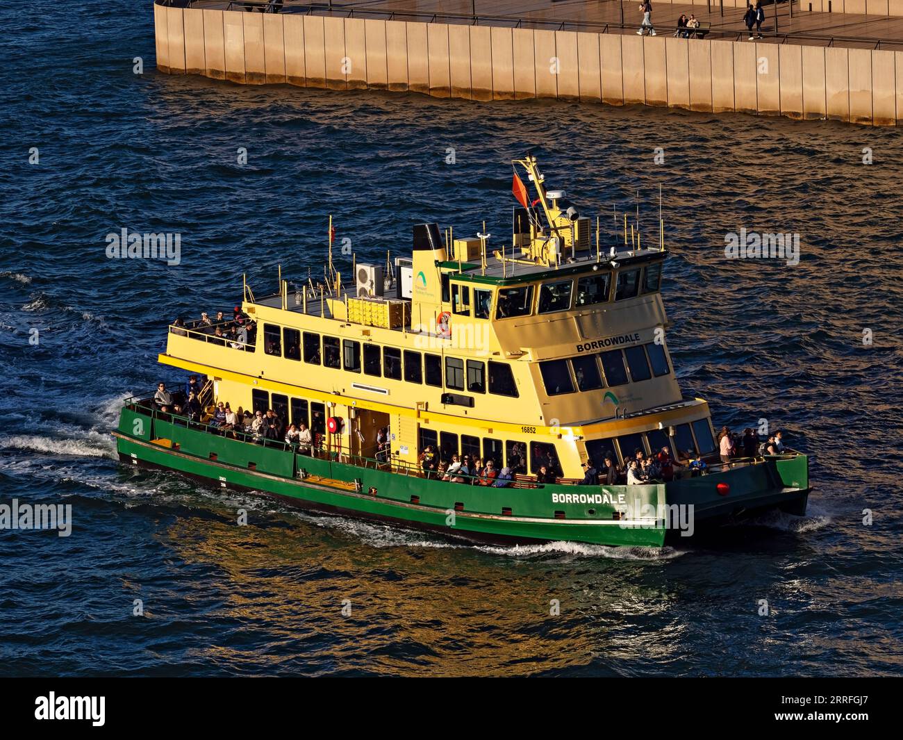 Sydney Australia / A Sydney commuter ferry passes the Sydney Opera ...