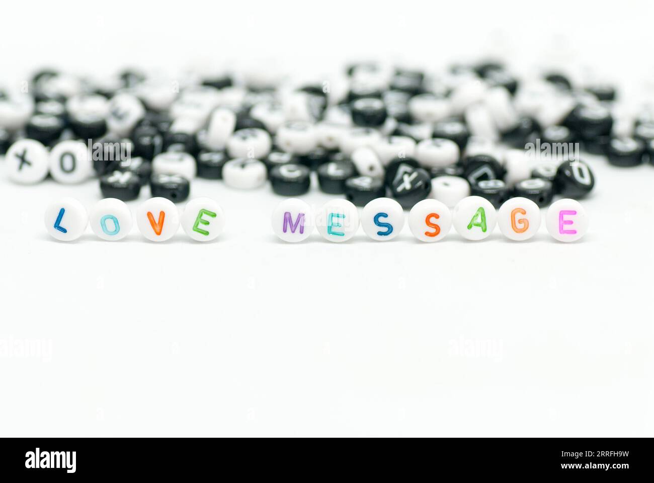 black and white round letters and love message written with colored ...