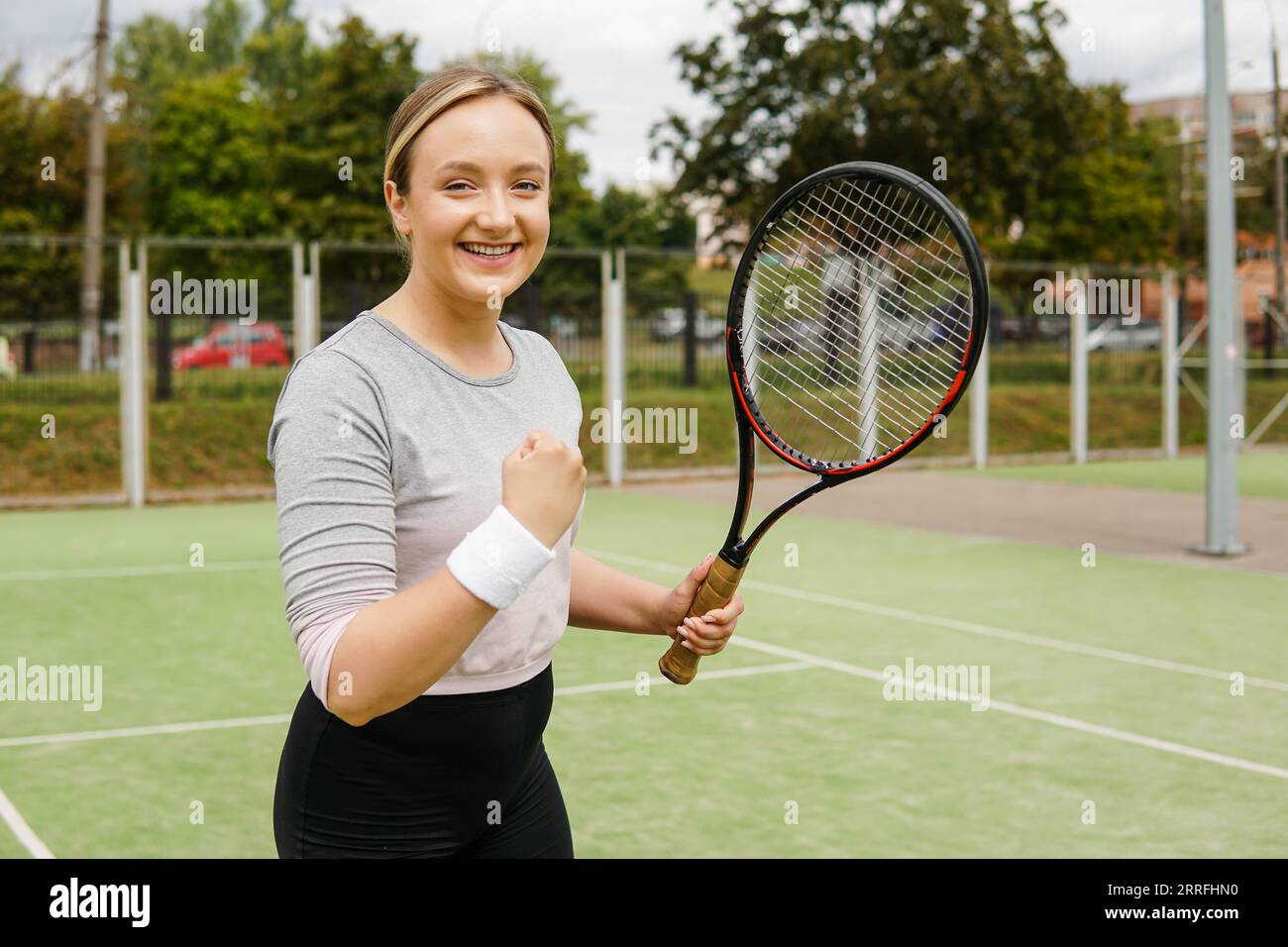 Portrait of young woman professional female tennis player in uniform ...