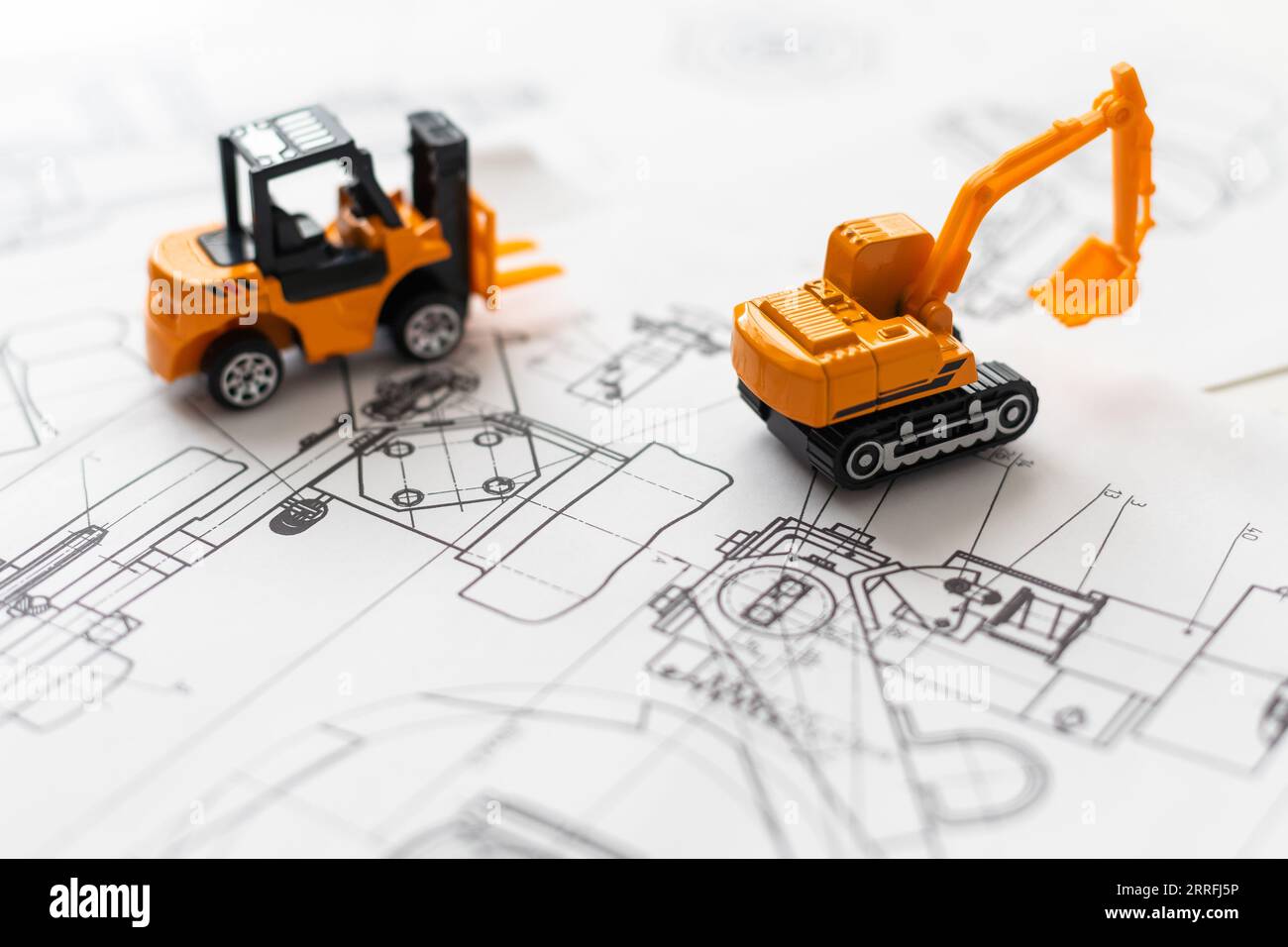 Toy construction machine builds model of house at the drawings Stock ...