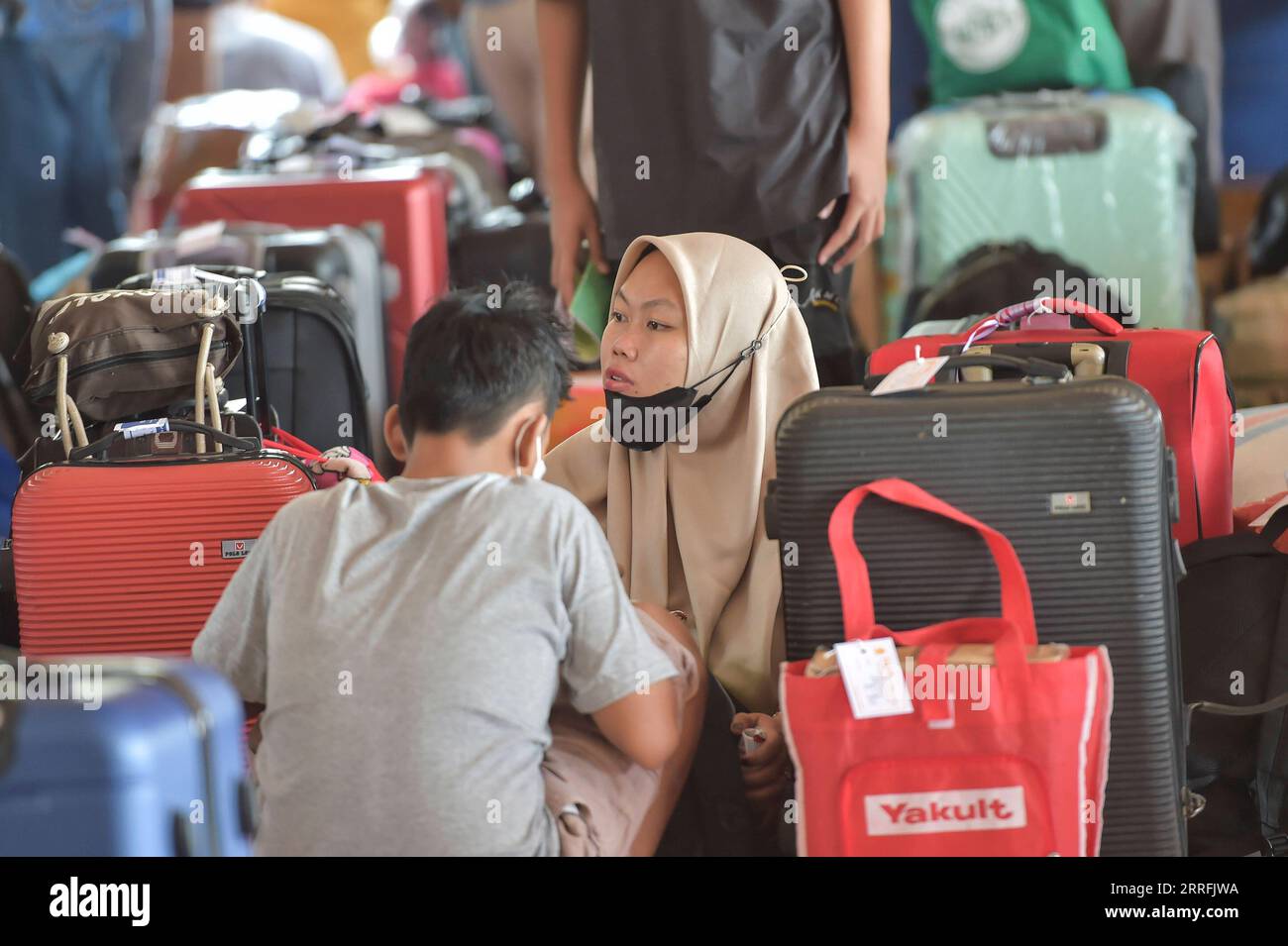 220420 -- JAKARTA, April 20, 2022 -- Passengers wait for their buses ...