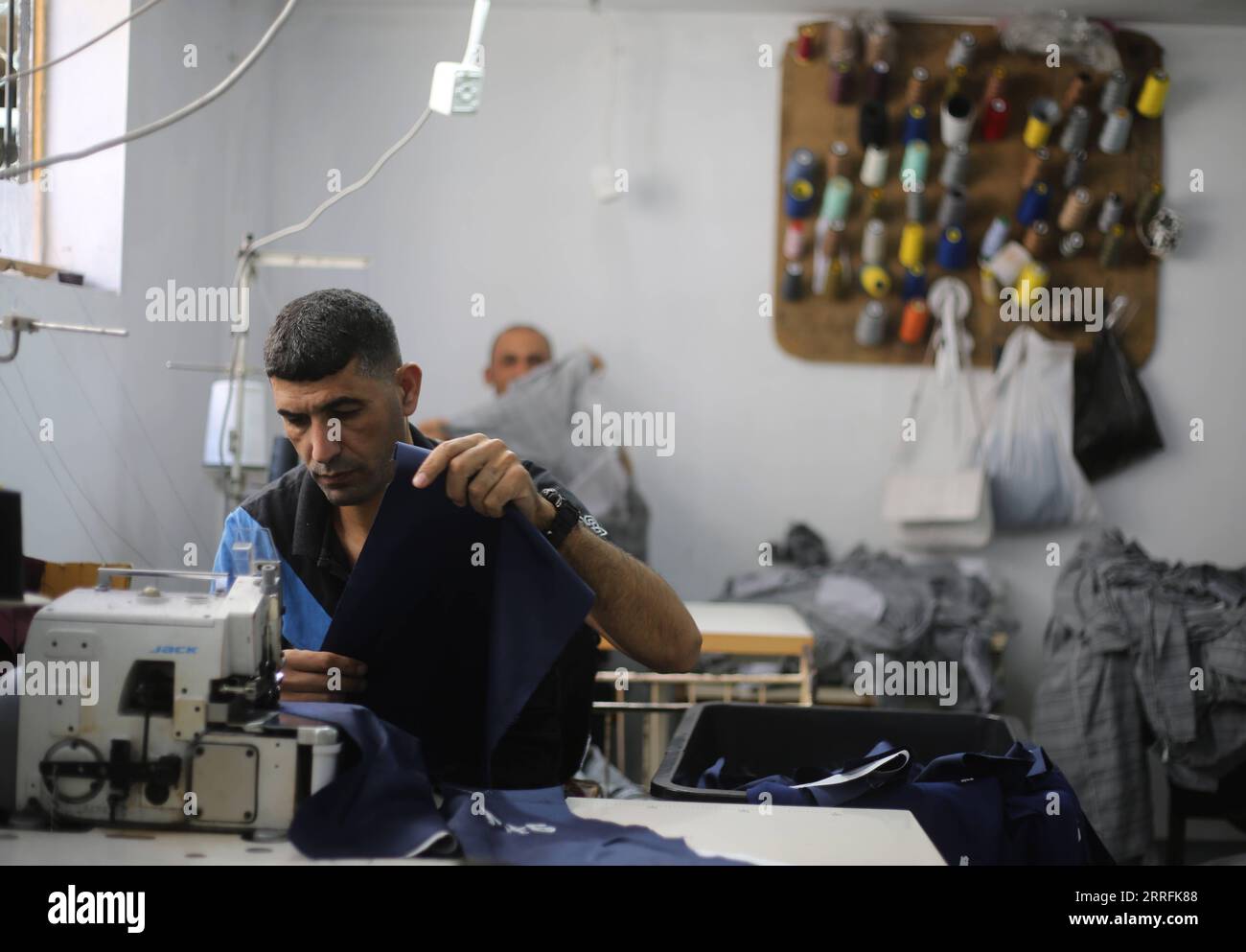 220420 -- RAFAH, April 20, 2022 -- A Palestinian tailor makes clothes ...