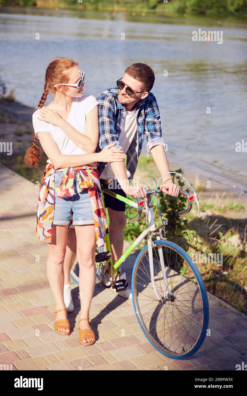 Full length portrait. Smiling woman with her boyfriend enjoying riding ...