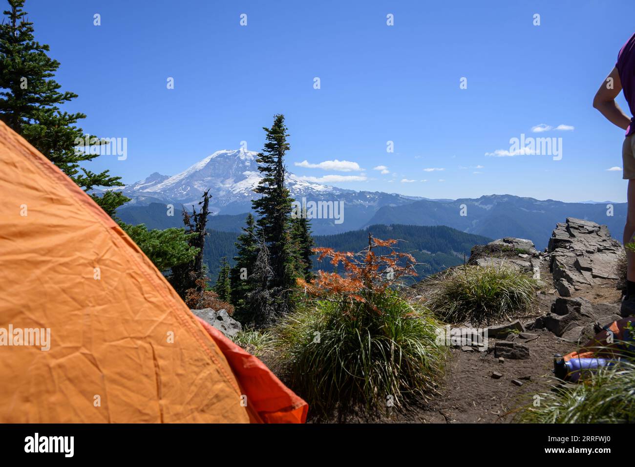 An orange tent and a young woman by the Summit Lake trail with Mount ...