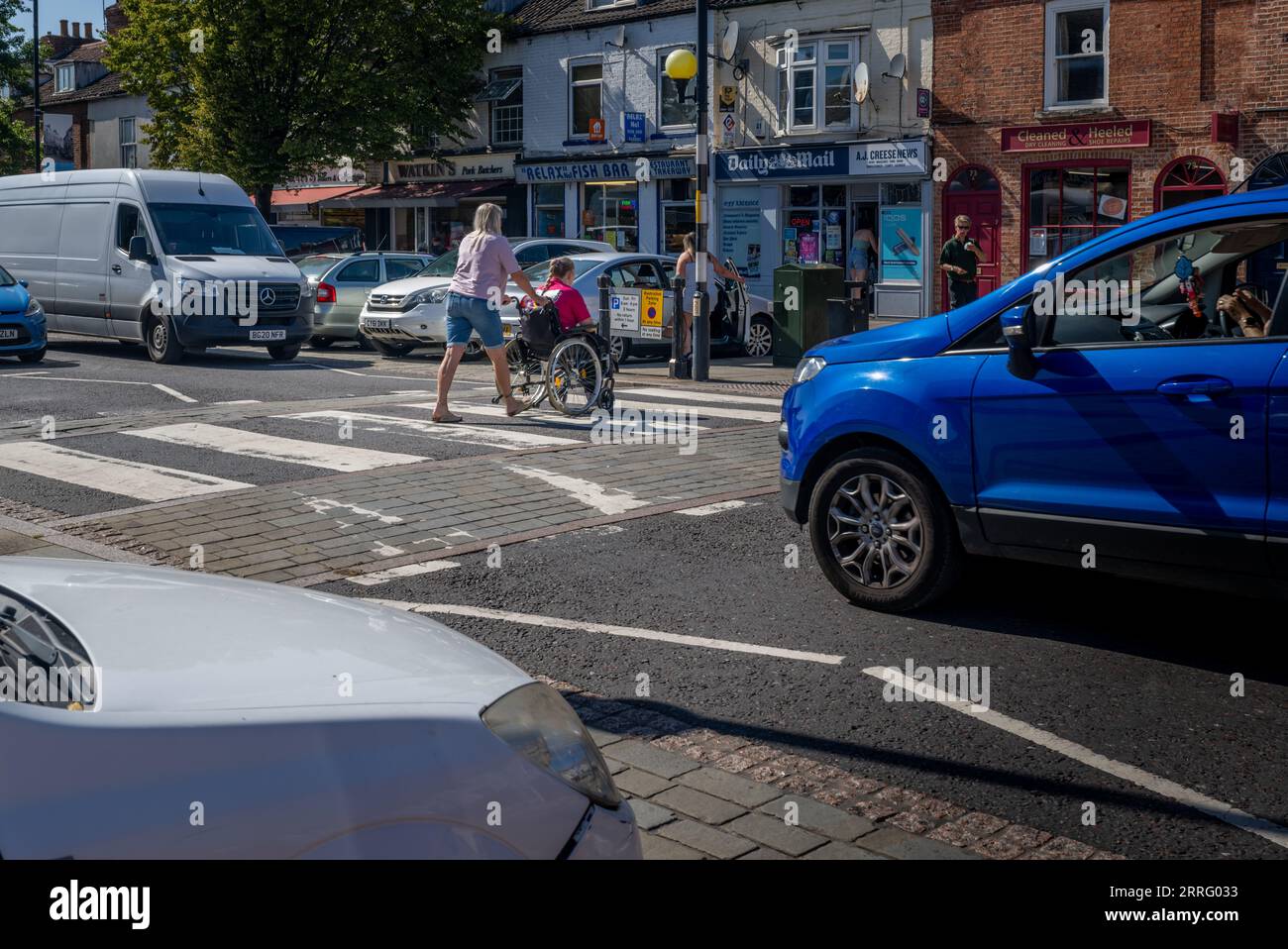 Wheelchair assisted crossing hi-res stock photography and images - Alamy
