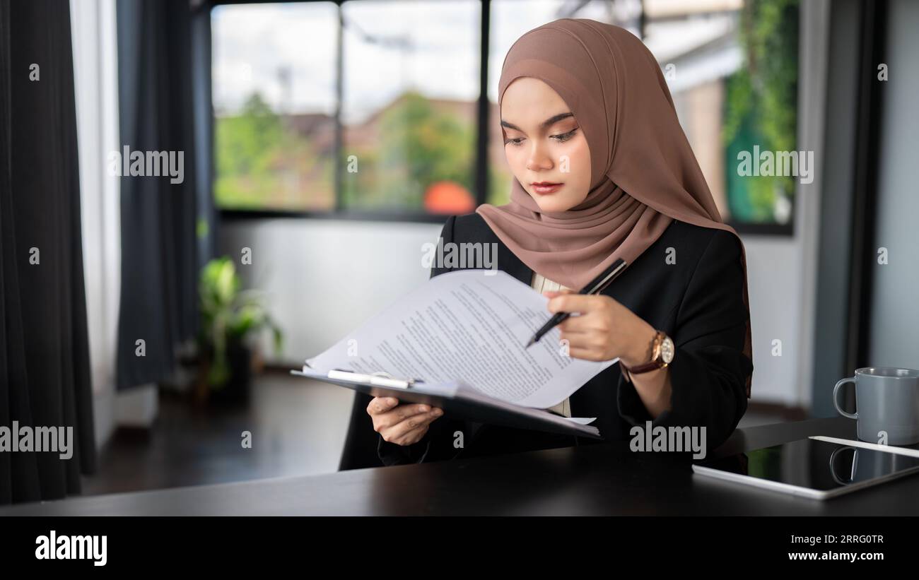 A professional adult Asian Muslim businesswoman or female manager in a ...
