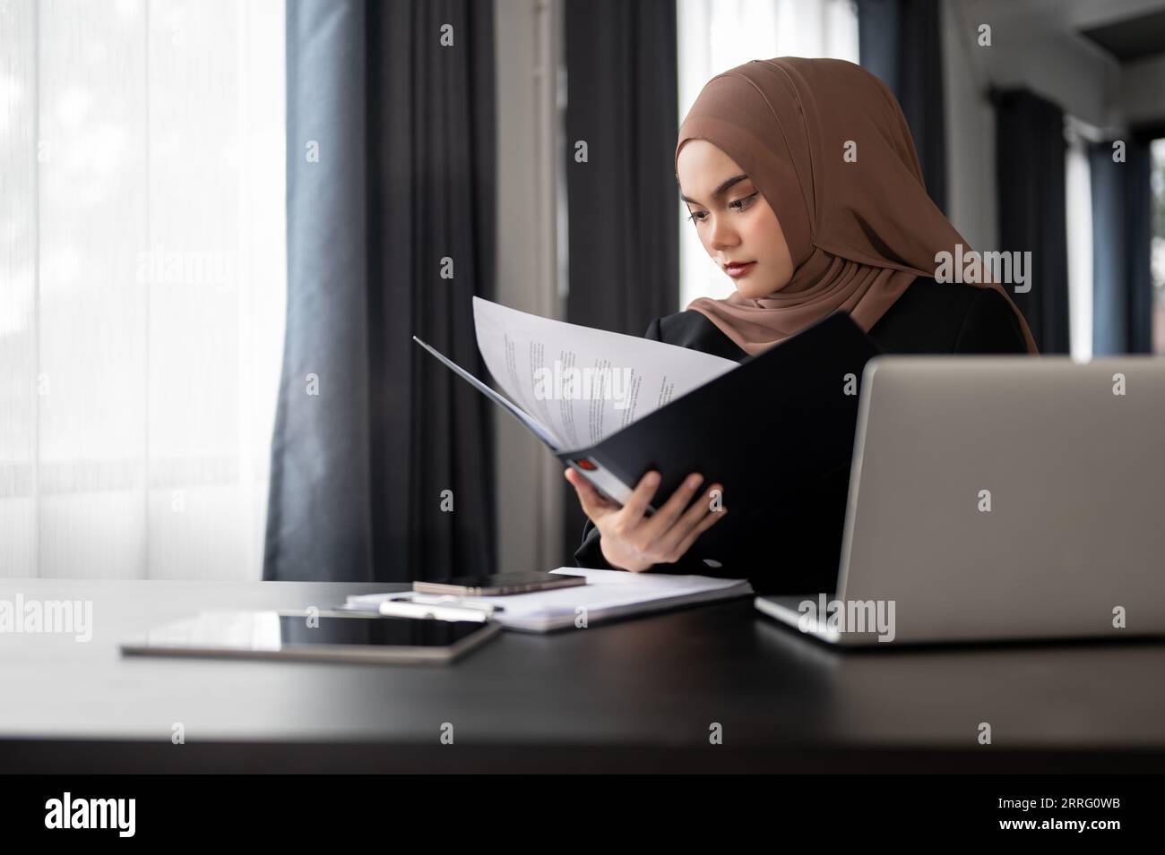 A professional adult Asian Muslim businesswoman or female manager ...
