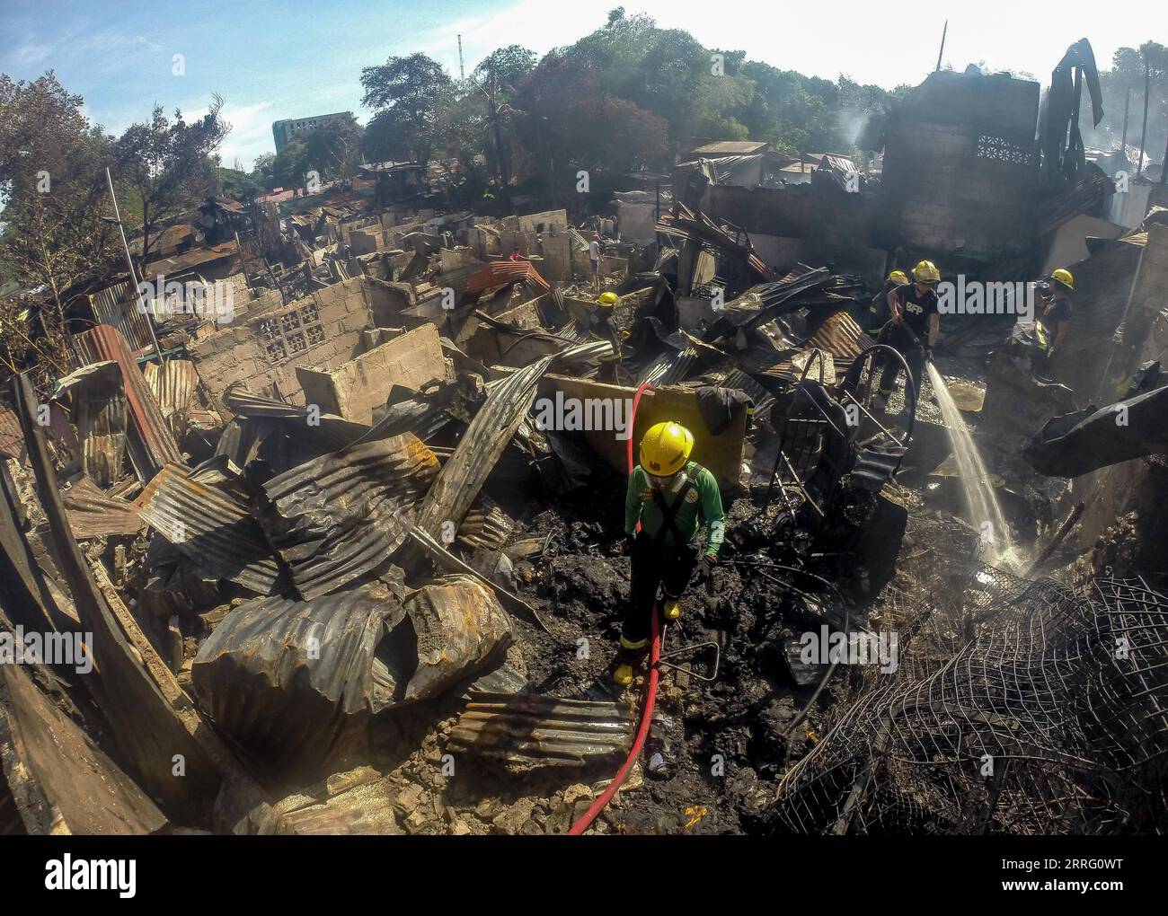 220502 -- QUEZON CITY, May 2, 2022 -- Firefighters work after a fire ...