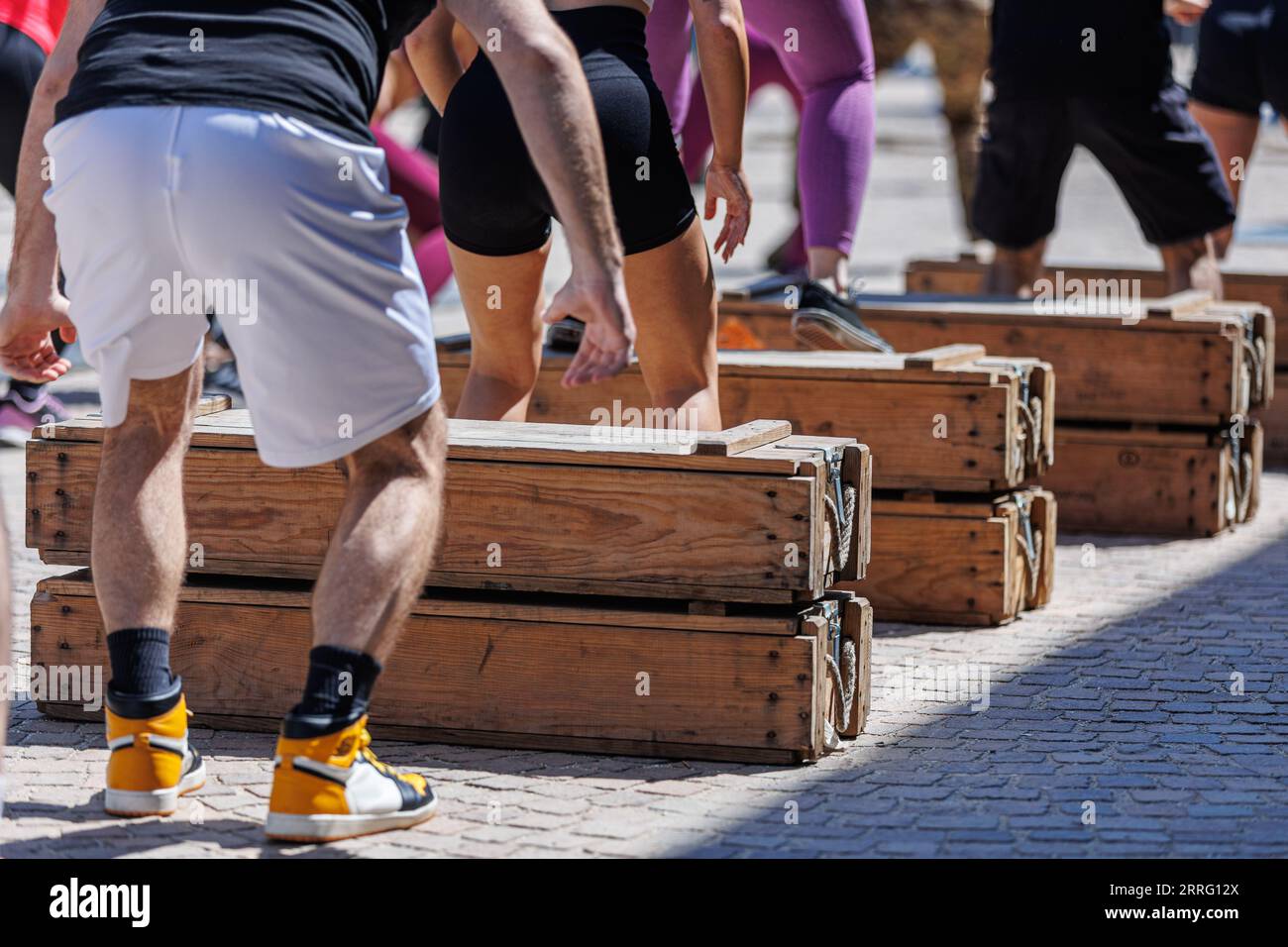 People Having Workout Jumping over Wooden Hurdles, Fitness, Gym ...