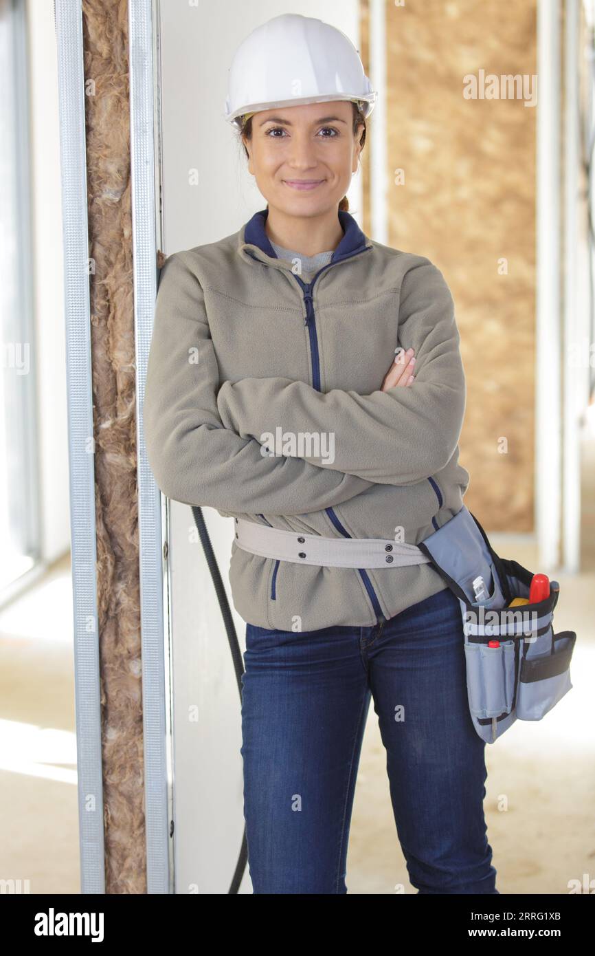 woman builder posing next to wool insulation pannel Stock Photo - Alamy