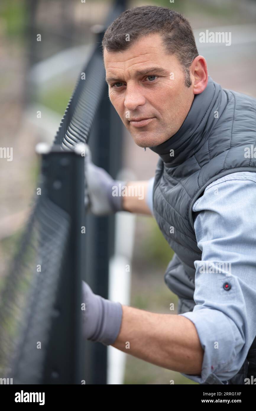 Installing metal fence hi-res stock photography and images - Alamy