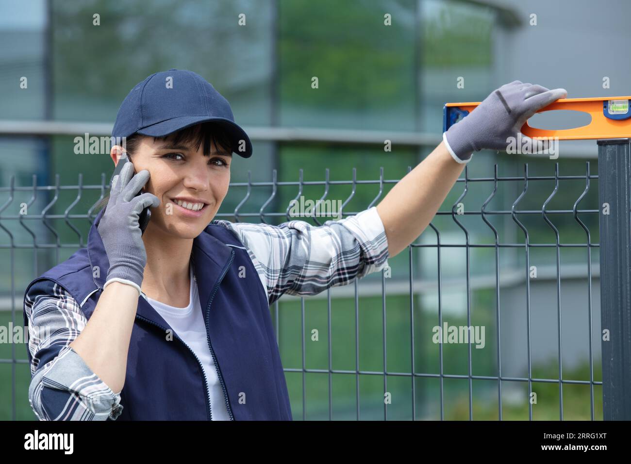 worker installing welded metal mesh fence Stock Photo - Alamy