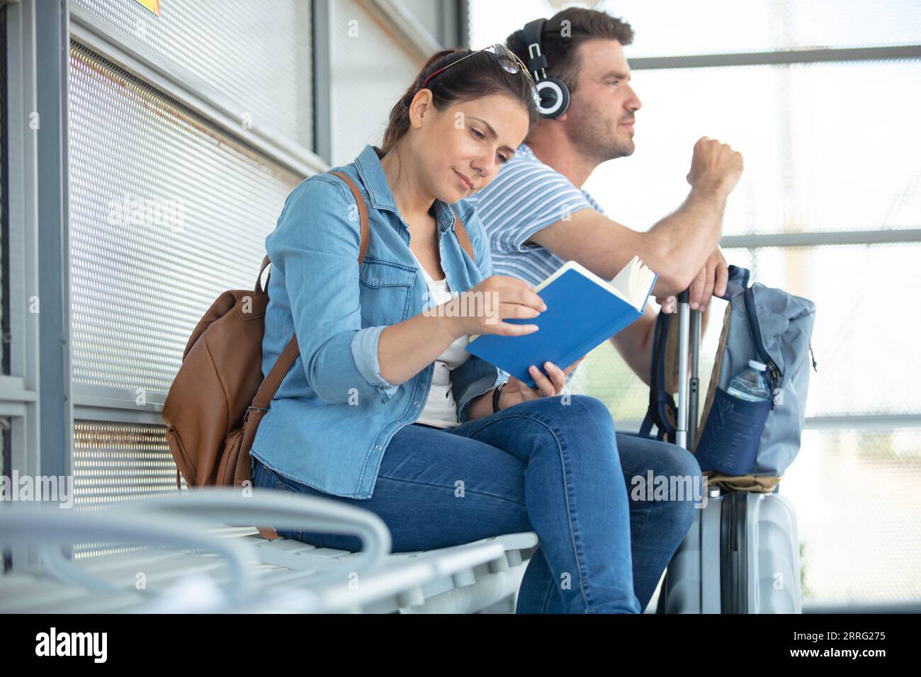 two person are waiting at the train station Stock Photo - Alamy