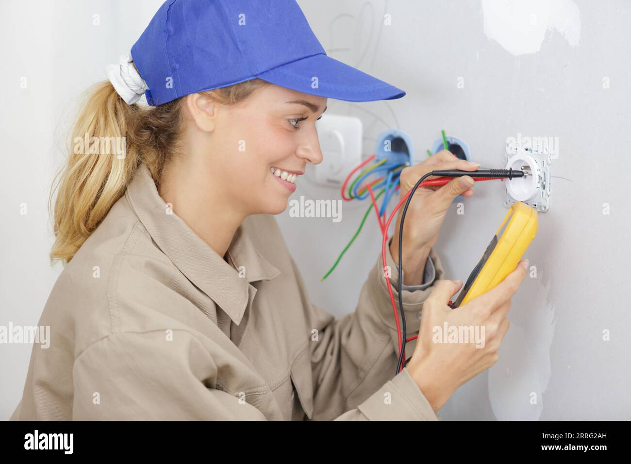 portrait of a woman measuring electrical current Stock Photo - Alamy