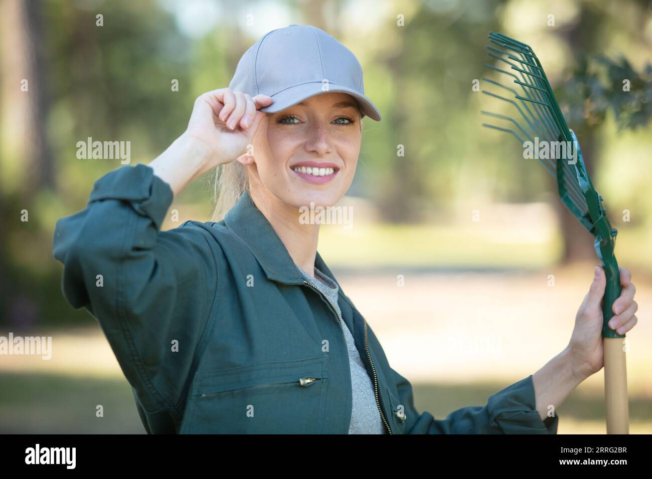 Woman tidying autumn leaves hi-res stock photography and images - Alamy