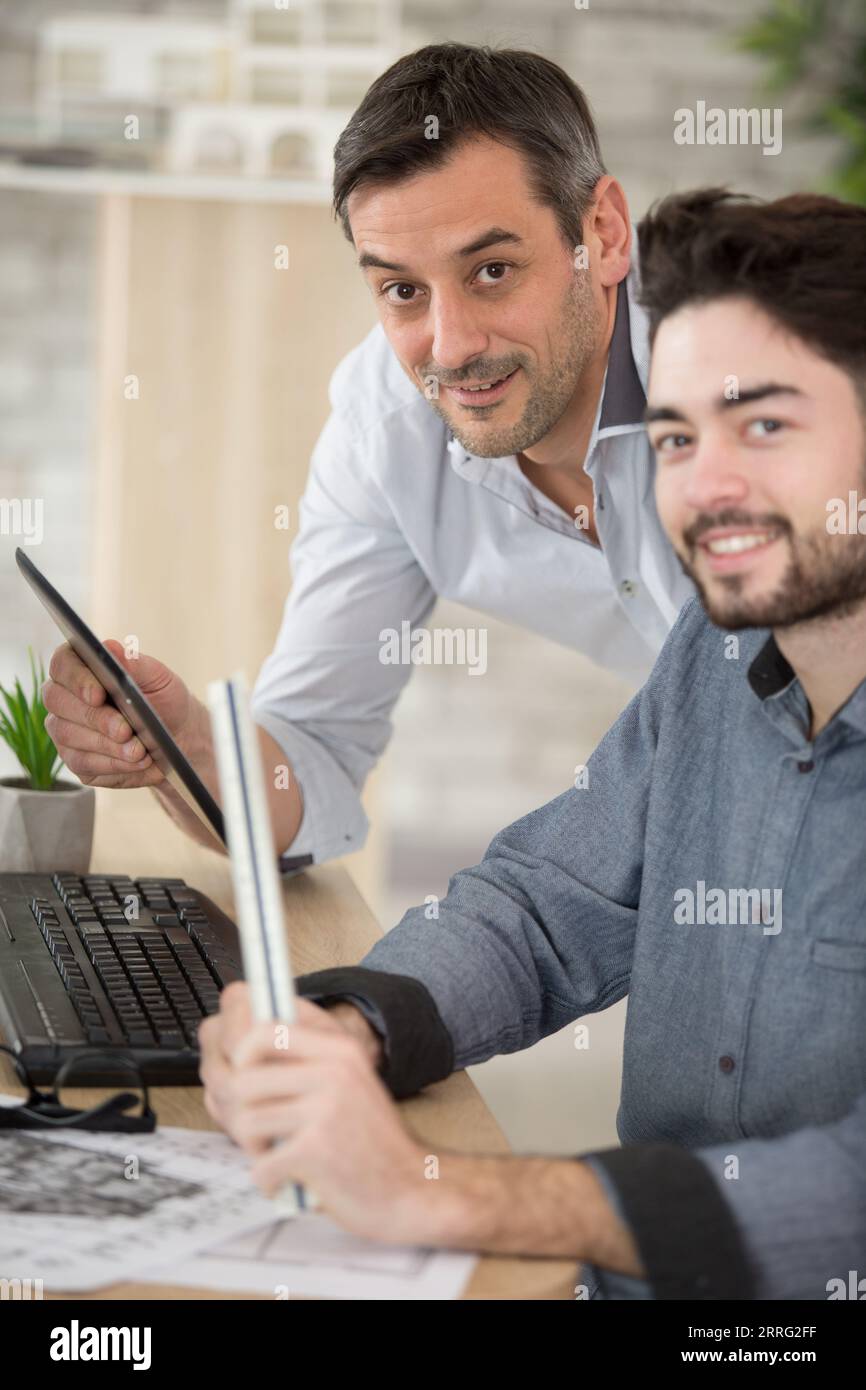 computer teacher assisting a student in classroom Stock Photo - Alamy