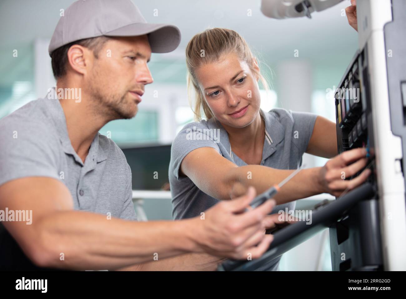 repair team working on industrial printer Stock Photo - Alamy