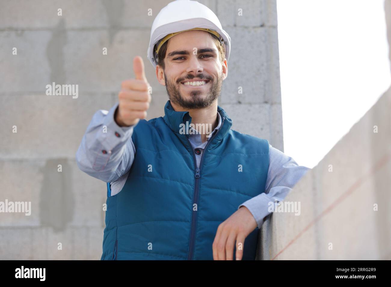 happy builder man laughing and making thumbs up at camera Stock Photo ...