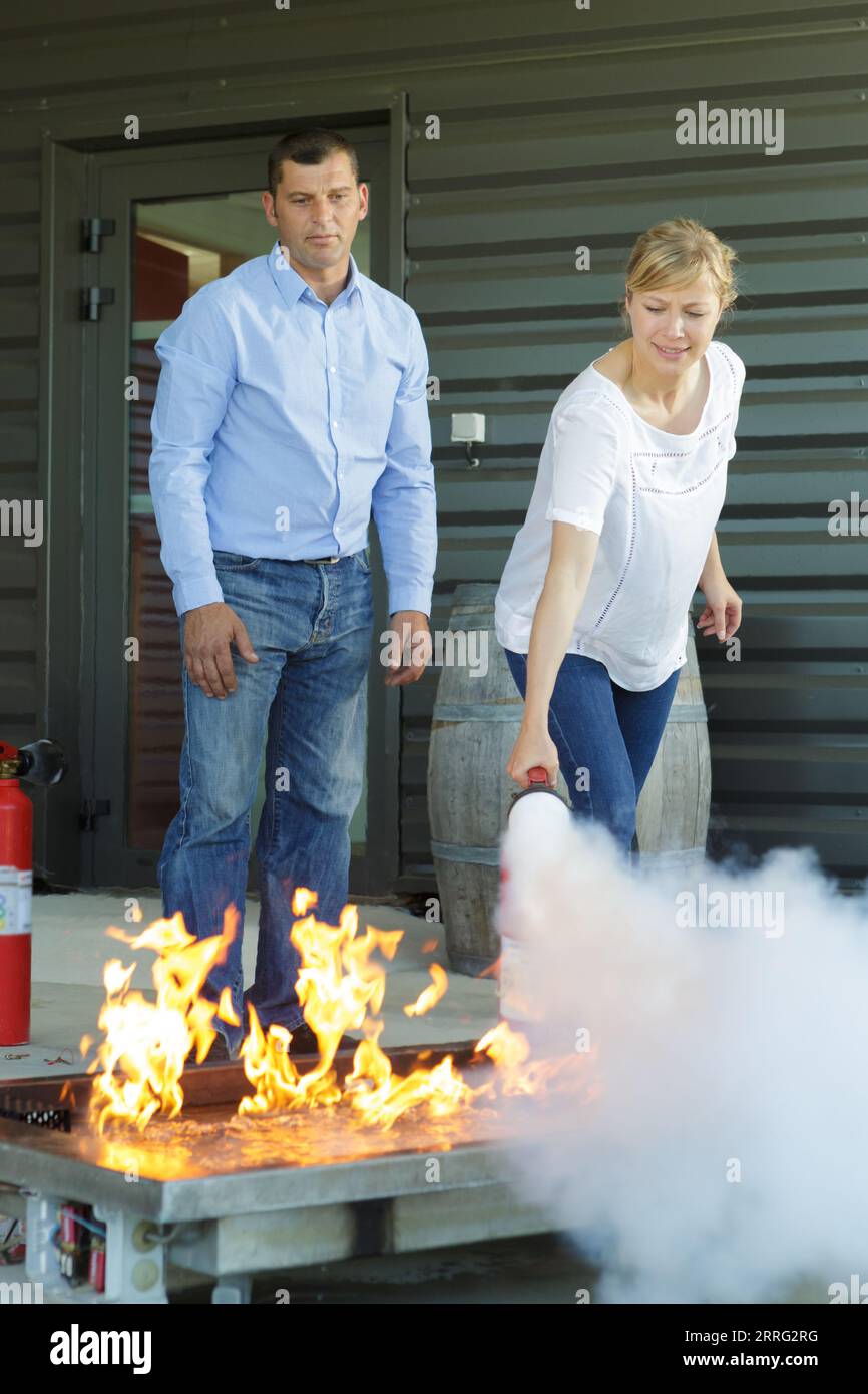 Man using fire extinguisher hi-res stock photography and images - Alamy