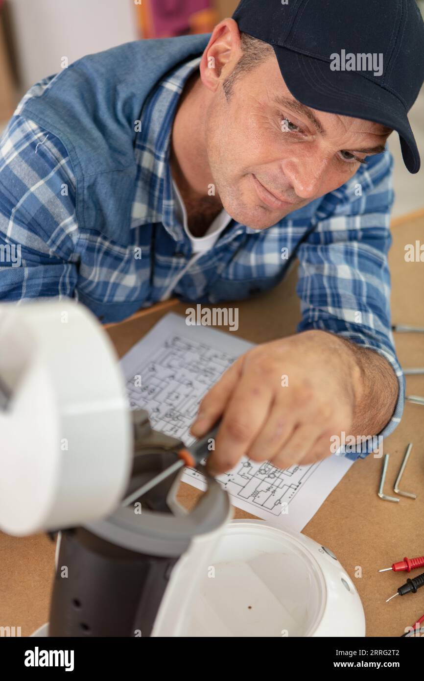 Male worker repairing coffee hi-res stock photography and images - Alamy