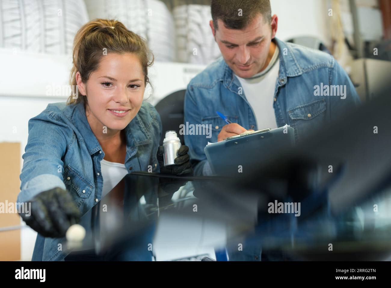 couple fixing a windshield window Stock Photo - Alamy