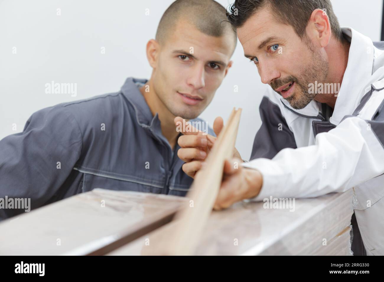 a carpenter training an apprentice Stock Photo - Alamy
