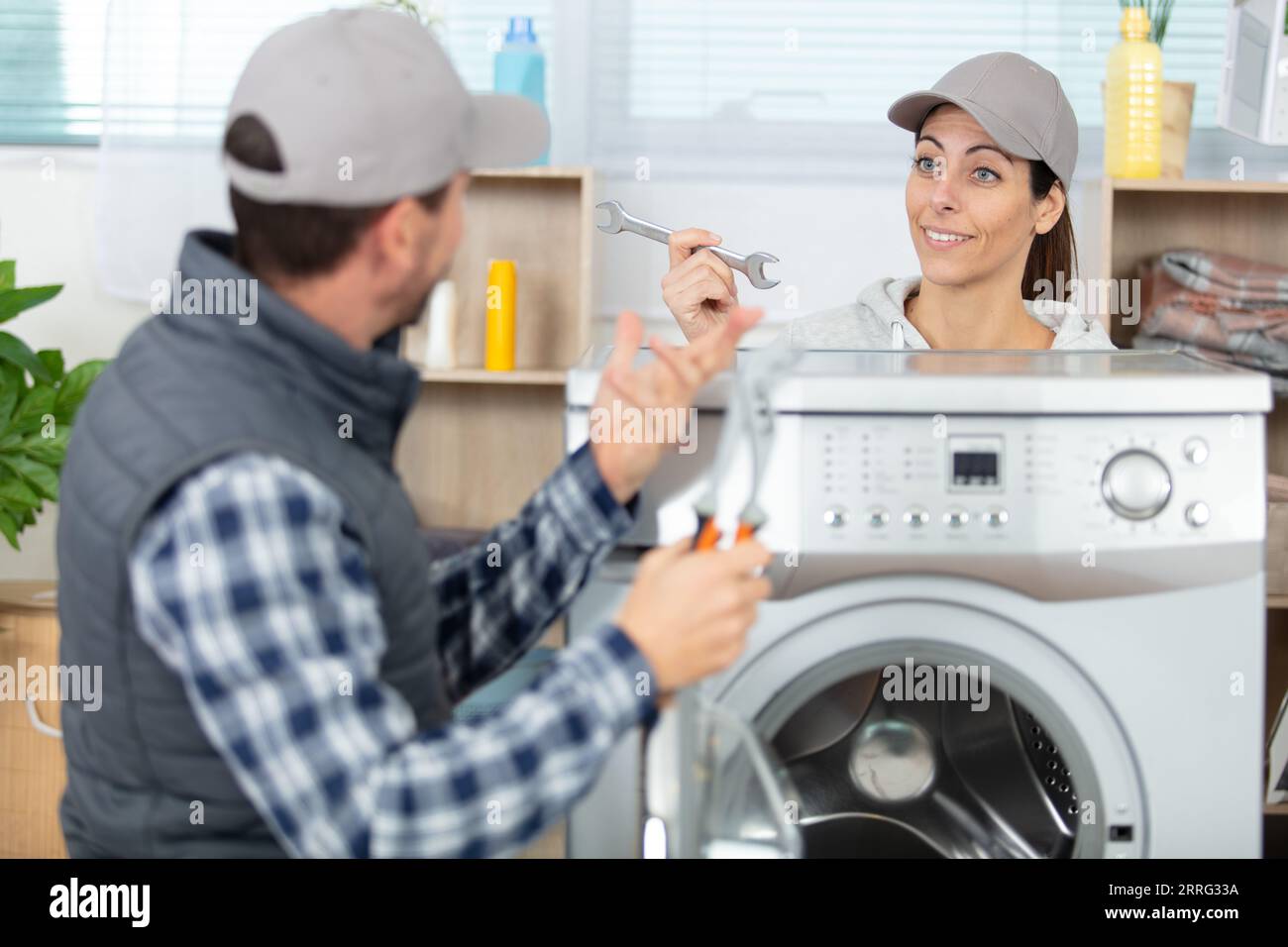 washing machine repair service contractors Stock Photo - Alamy