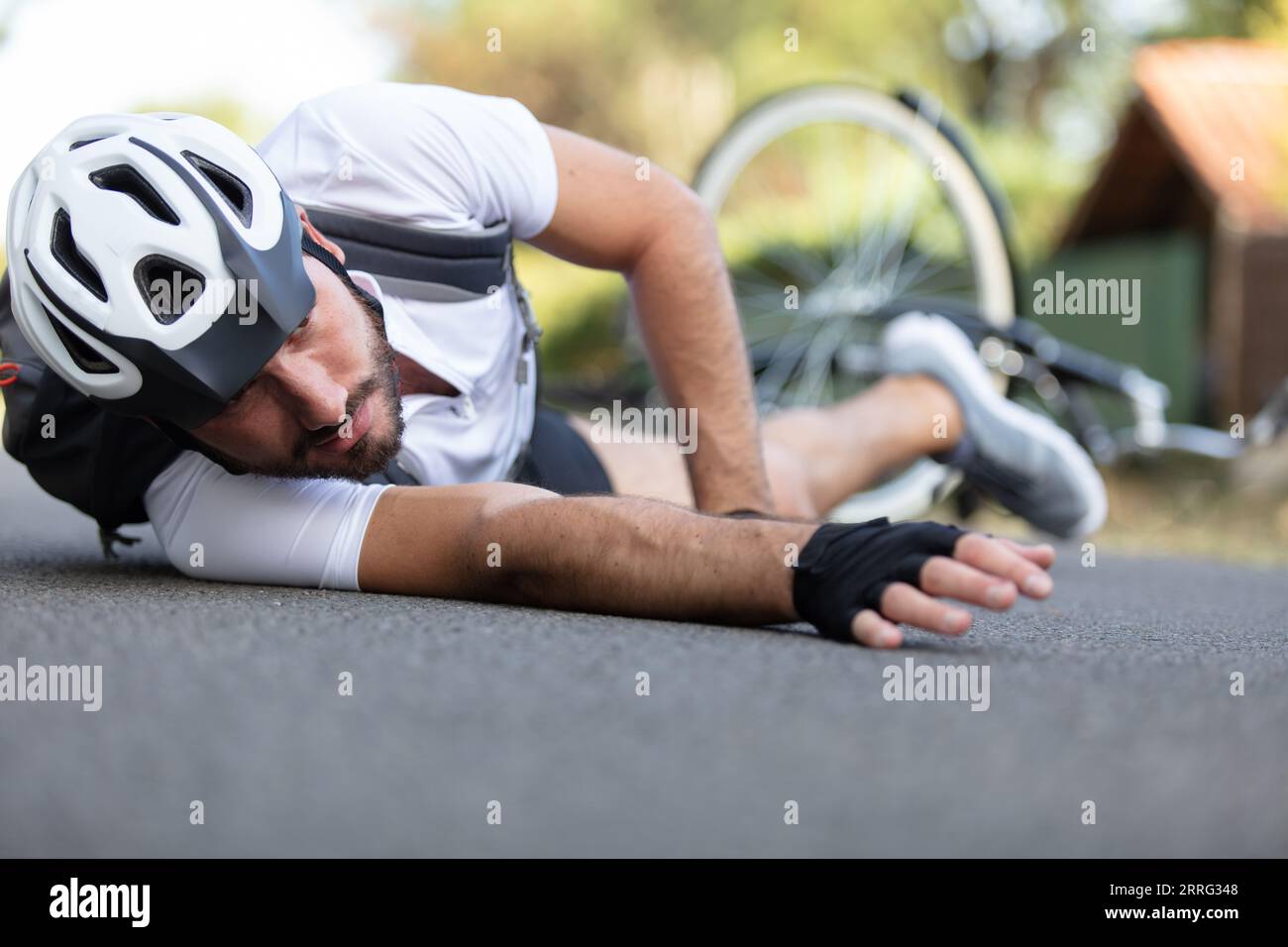 man falls off his bicycle Stock Photo - Alamy