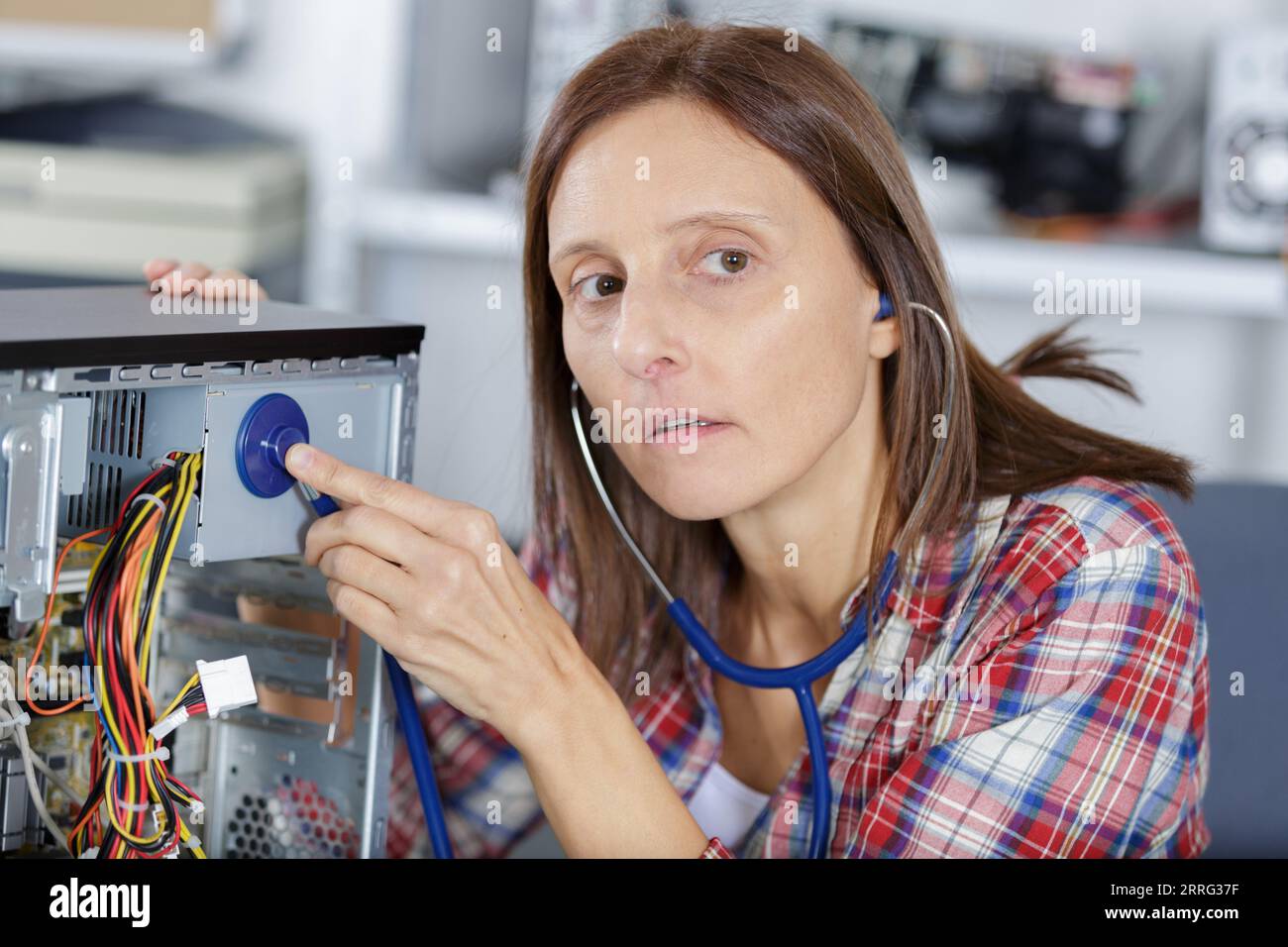woman holding stethoscope repair computer motherboard Stock Photo - Alamy
