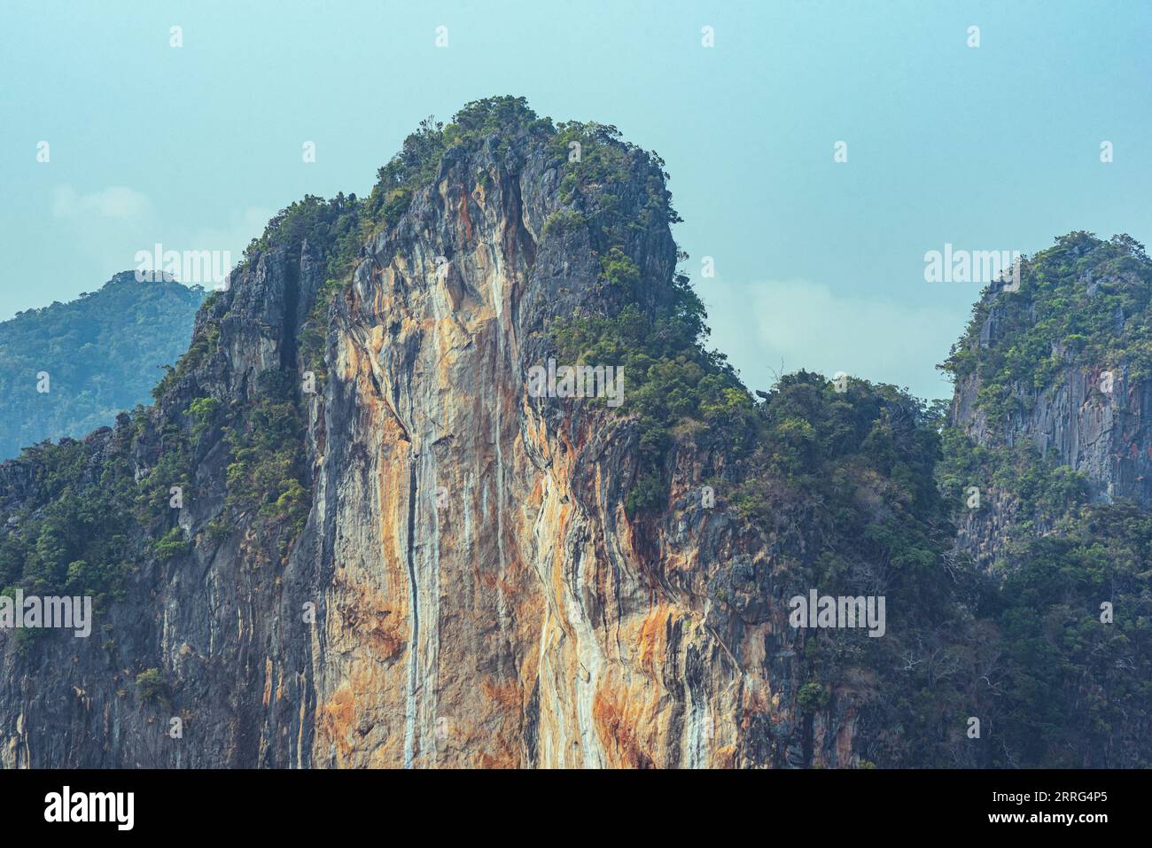 Limestone mountain covered with tropical forest against the blue sky ...