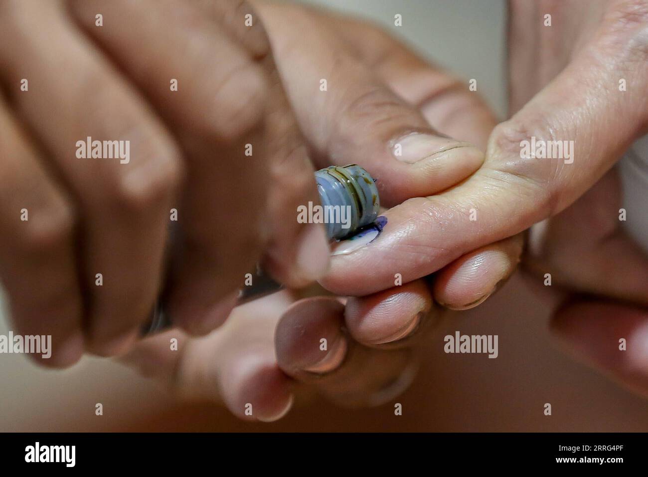 220509 -- MANILA, May 9, 2022 -- A voter has her index finger marked ...