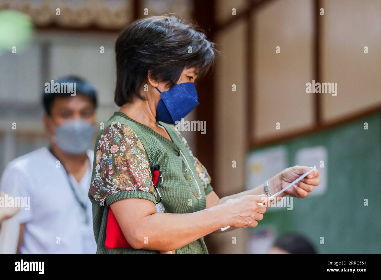 Woman checks vote polling hi-res stock photography and images - Alamy