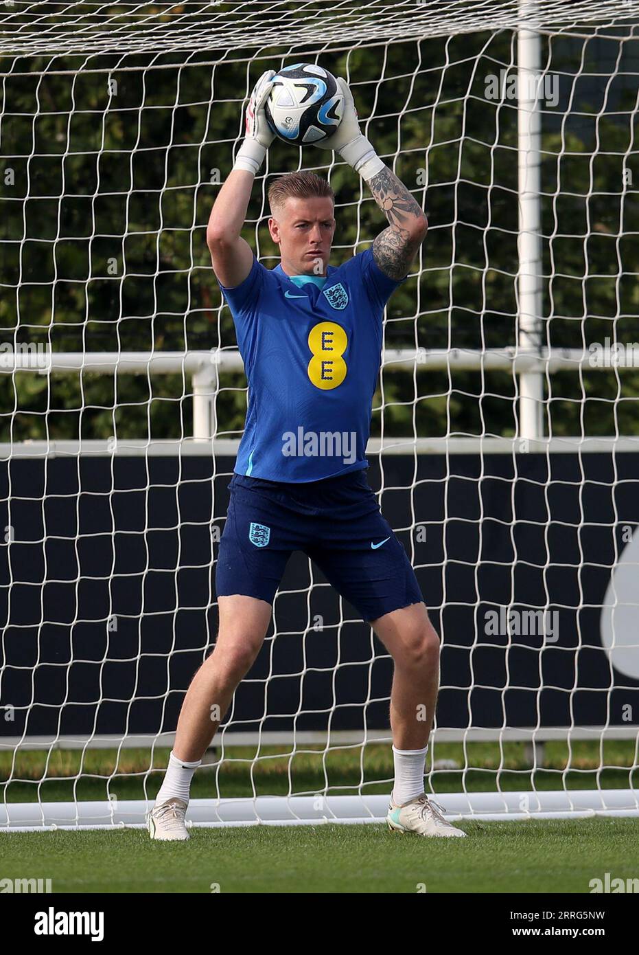 England’s Jordan Pickford warms up during a training session at St ...