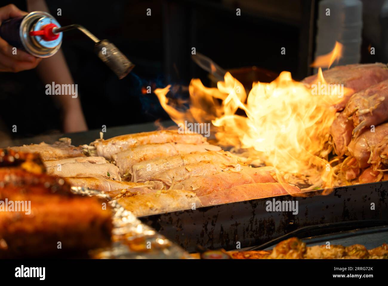 Grilling barbecue meatloaf rolled with vegetables, pork or beef at ...
