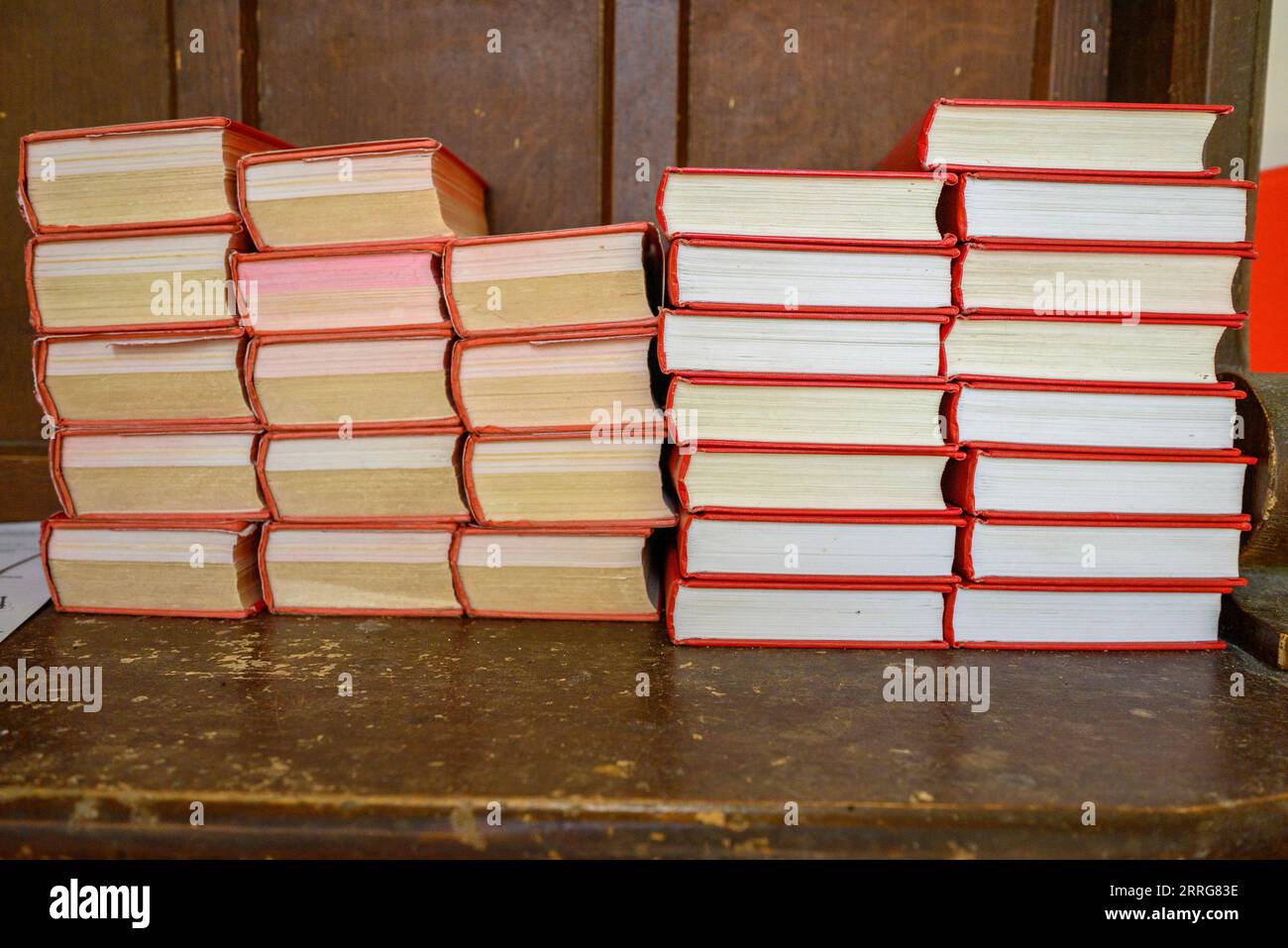 Prayer books stacked up in church Stock Photo - Alamy
