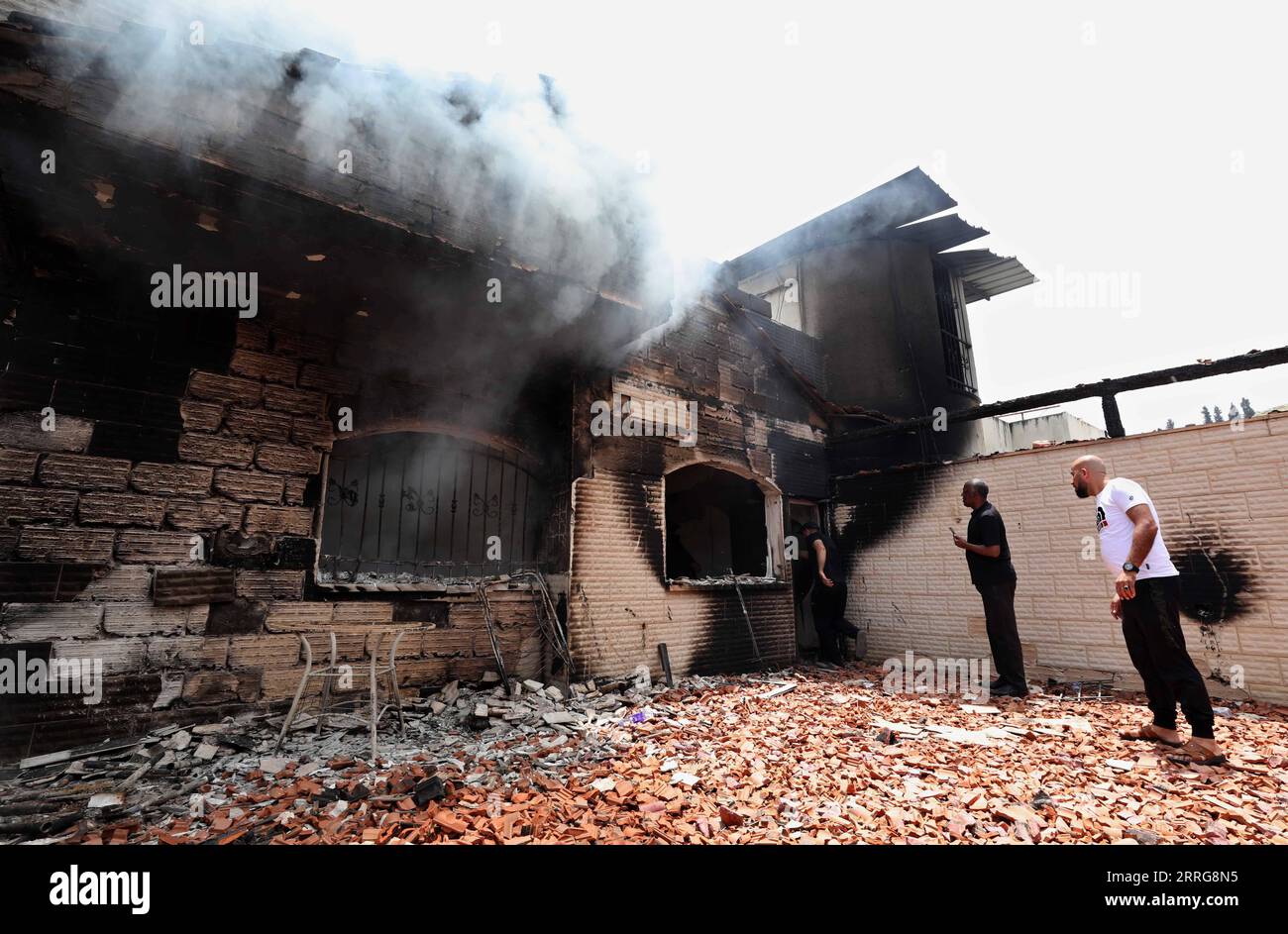 220513 -- JENIN, May 13, 2022 -- People inspect a destroyed house after ...