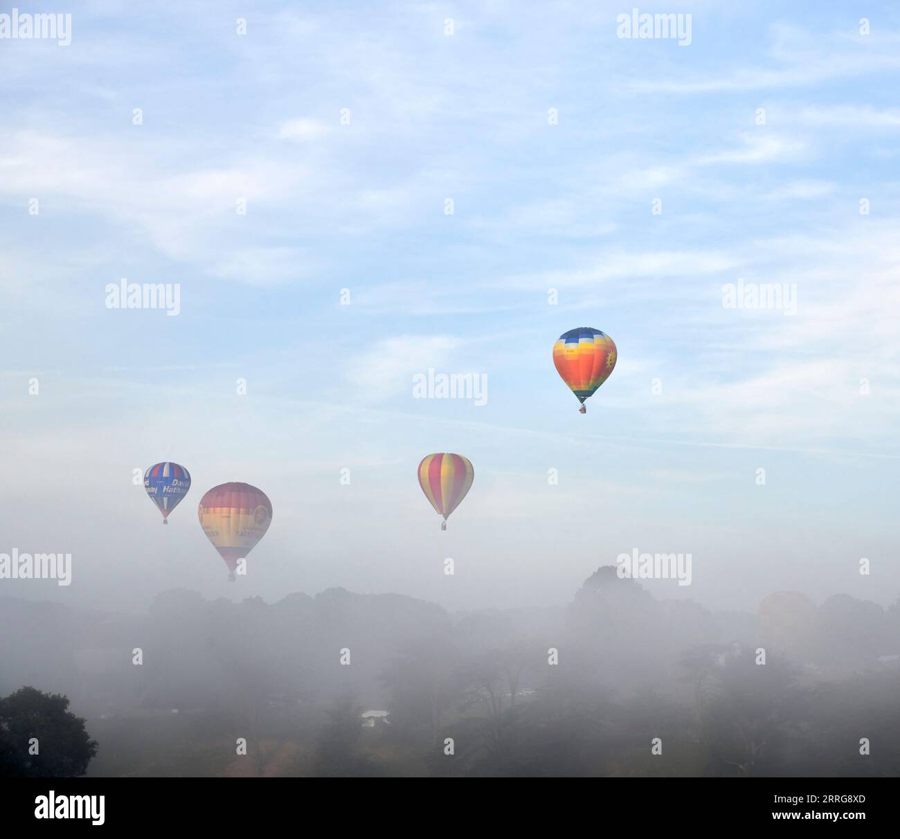 Hot Air Balloons rising from the mist in a mass accent at Chatsworth ...