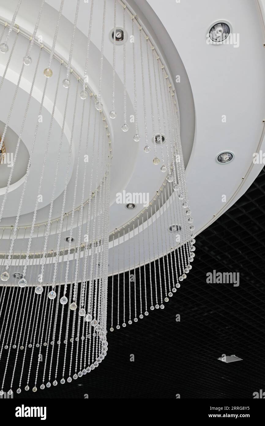 Giant luxury glass chandeliers on the ceiling Stock Photo - Alamy