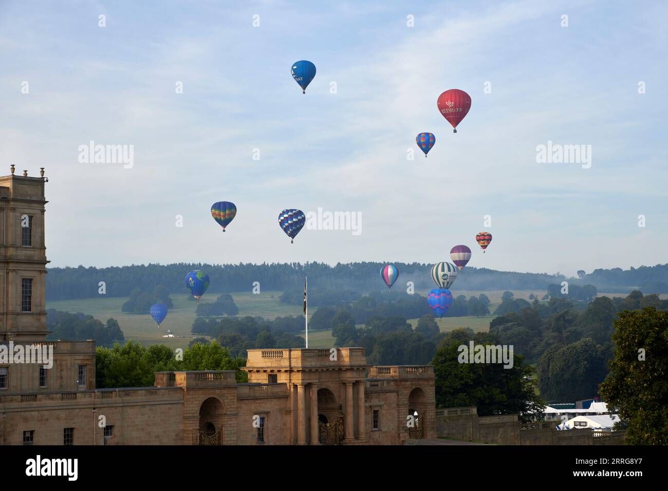 Hot Air Balloons rising from the mist in a mass accent at Chatsworth ...