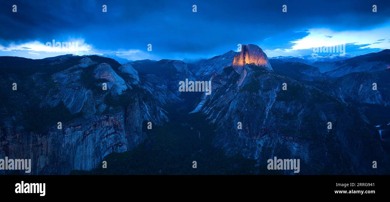 Setting sunbeam illuminates the peak of Half Dome monolith in Yosemite ...