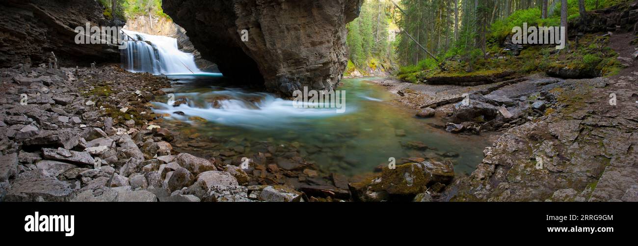 Rushing water carves a path through the limestone of Johnston Canyon in ...