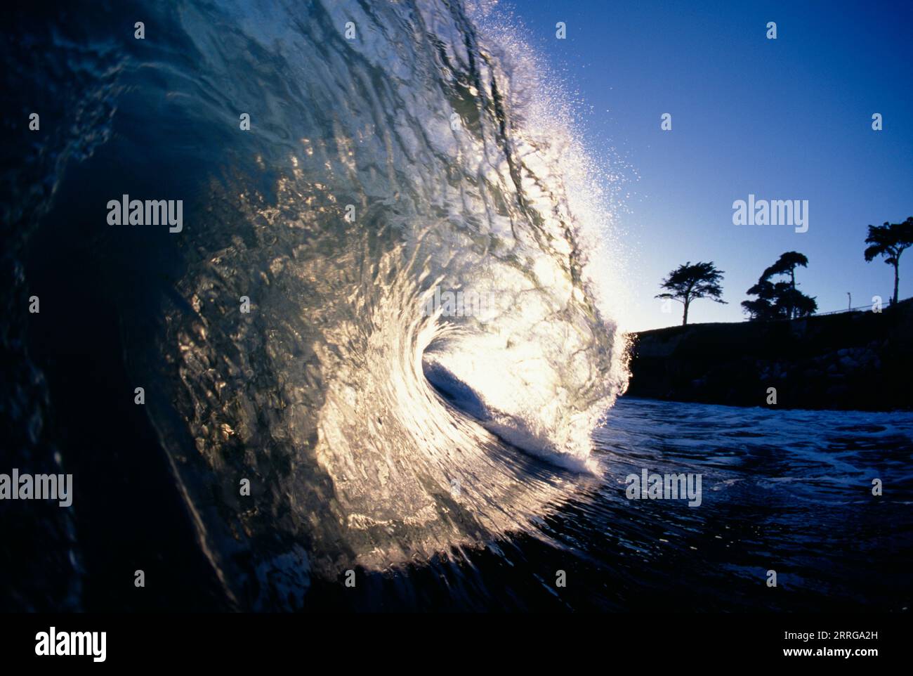 View of the inside of a crashing wave in the late afternoon in Santa ...