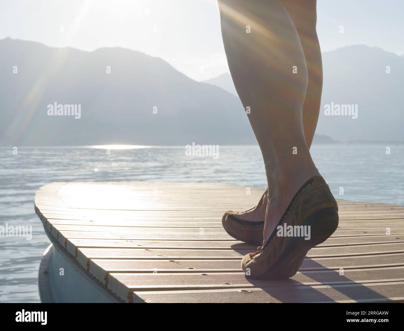 Low angle detail of feet walking out on dock Stock Photo - Alamy