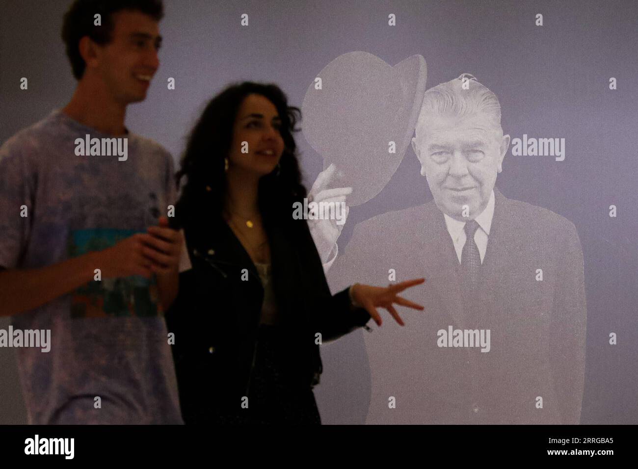 220516 -- BRUSSELS, May 16, 2022 -- Visitors walk past an image of Rene ...