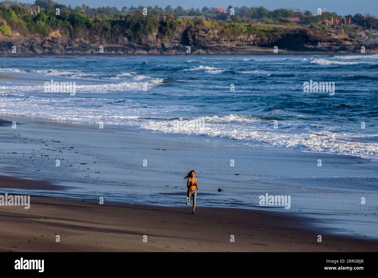 Running on the beach in Bali, Indonesia Stock Photo - Alamy