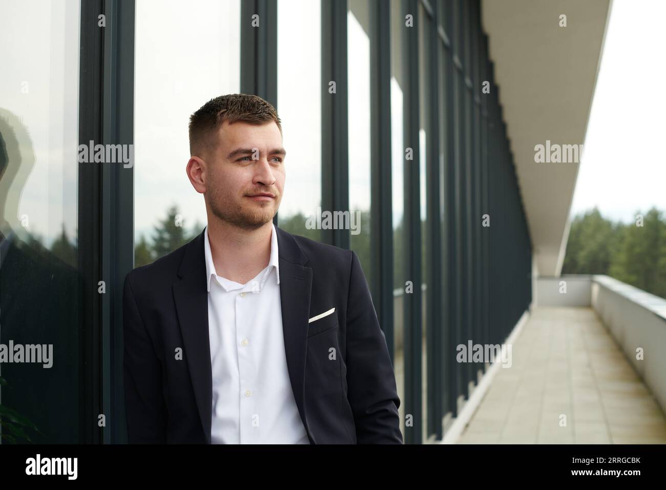 A CEO dressed in a sleek black suit stands confidently at the entrance ...