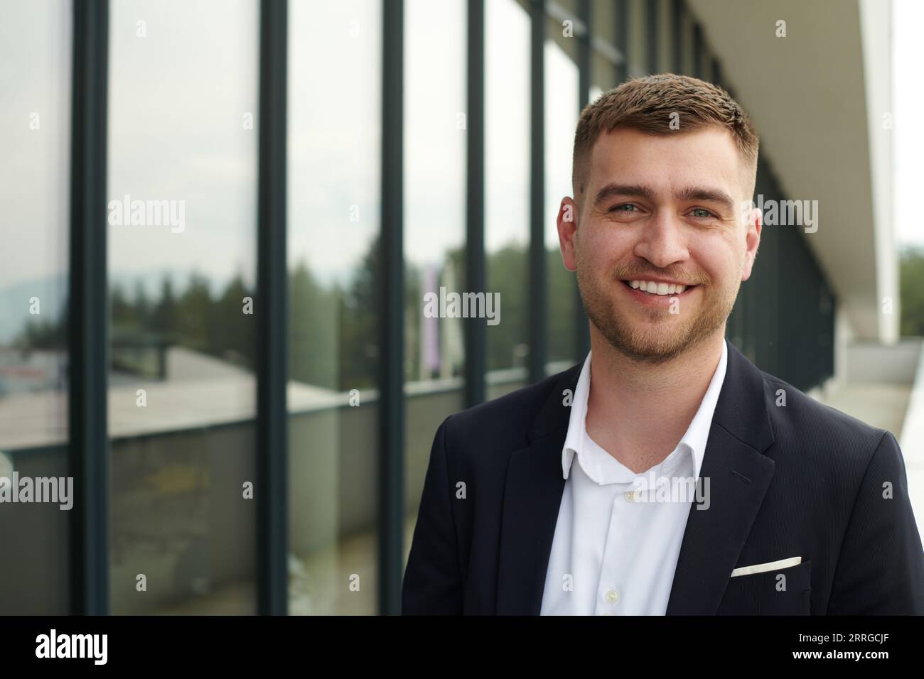A CEO dressed in a sleek black suit stands confidently at the entrance ...