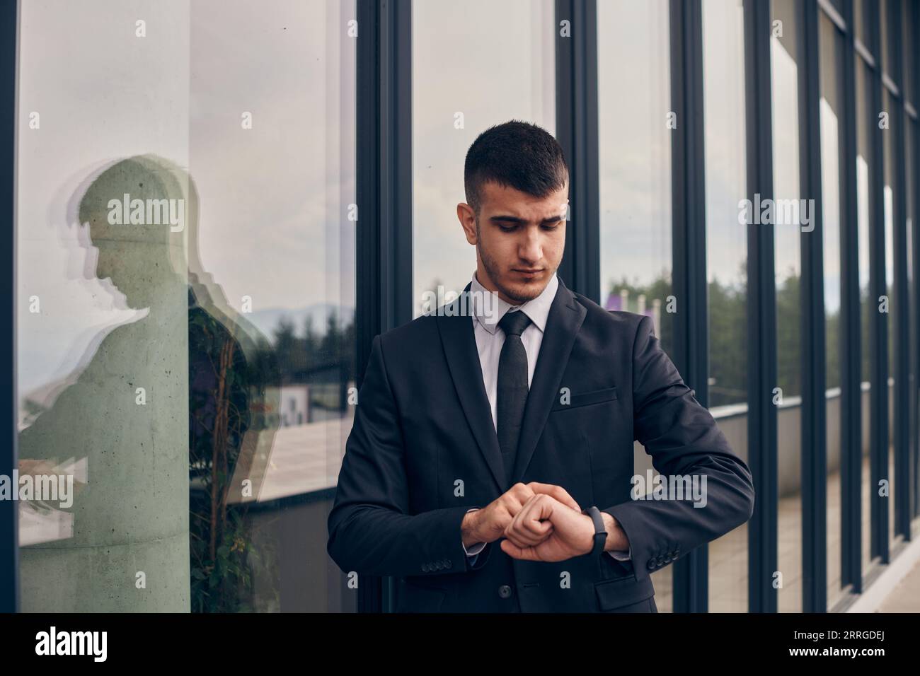 A CEO dressed in a sleek black suit stands confidently at the entrance ...