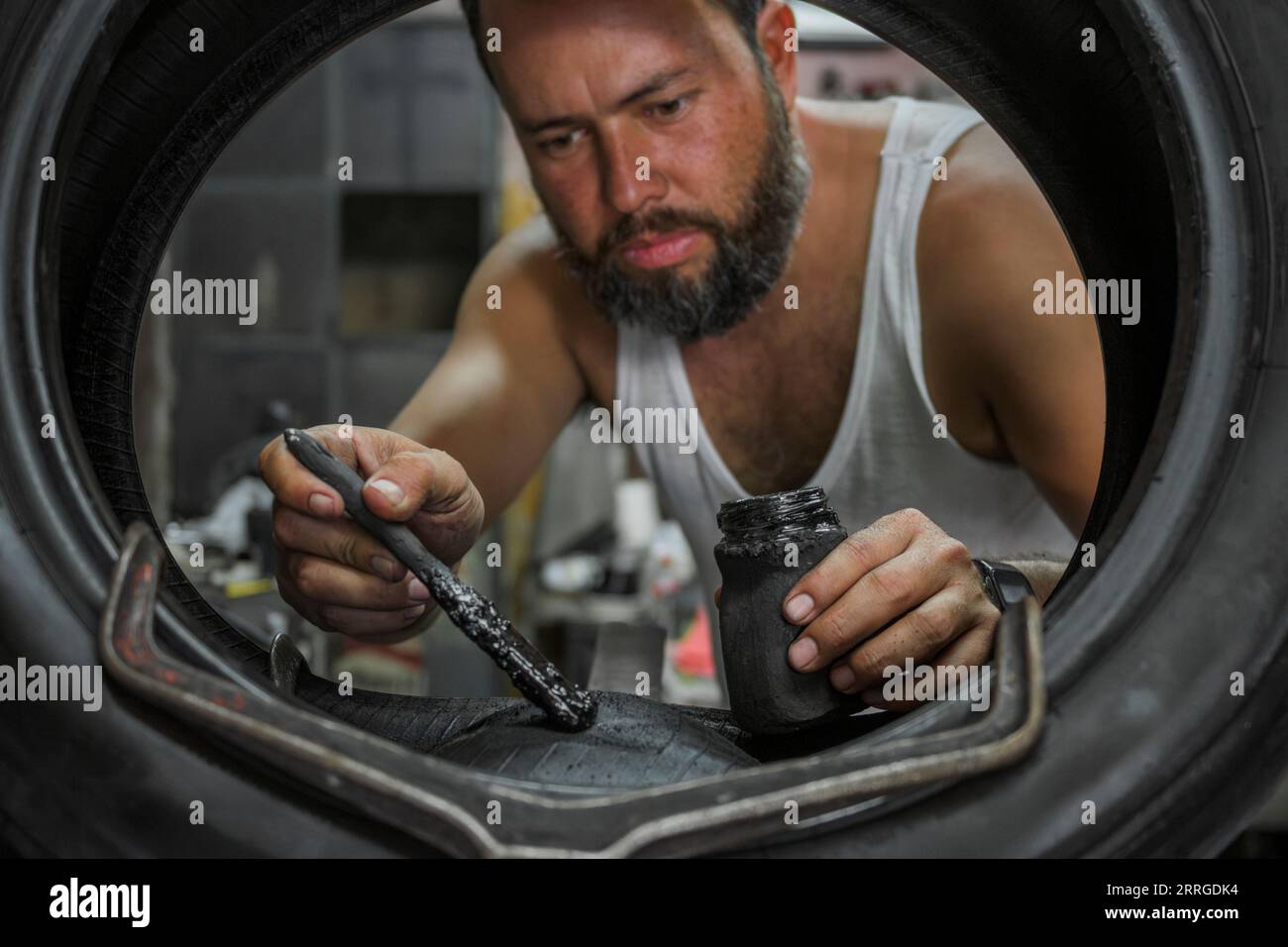 Man fixing a flat tire hi-res stock photography and images - Alamy